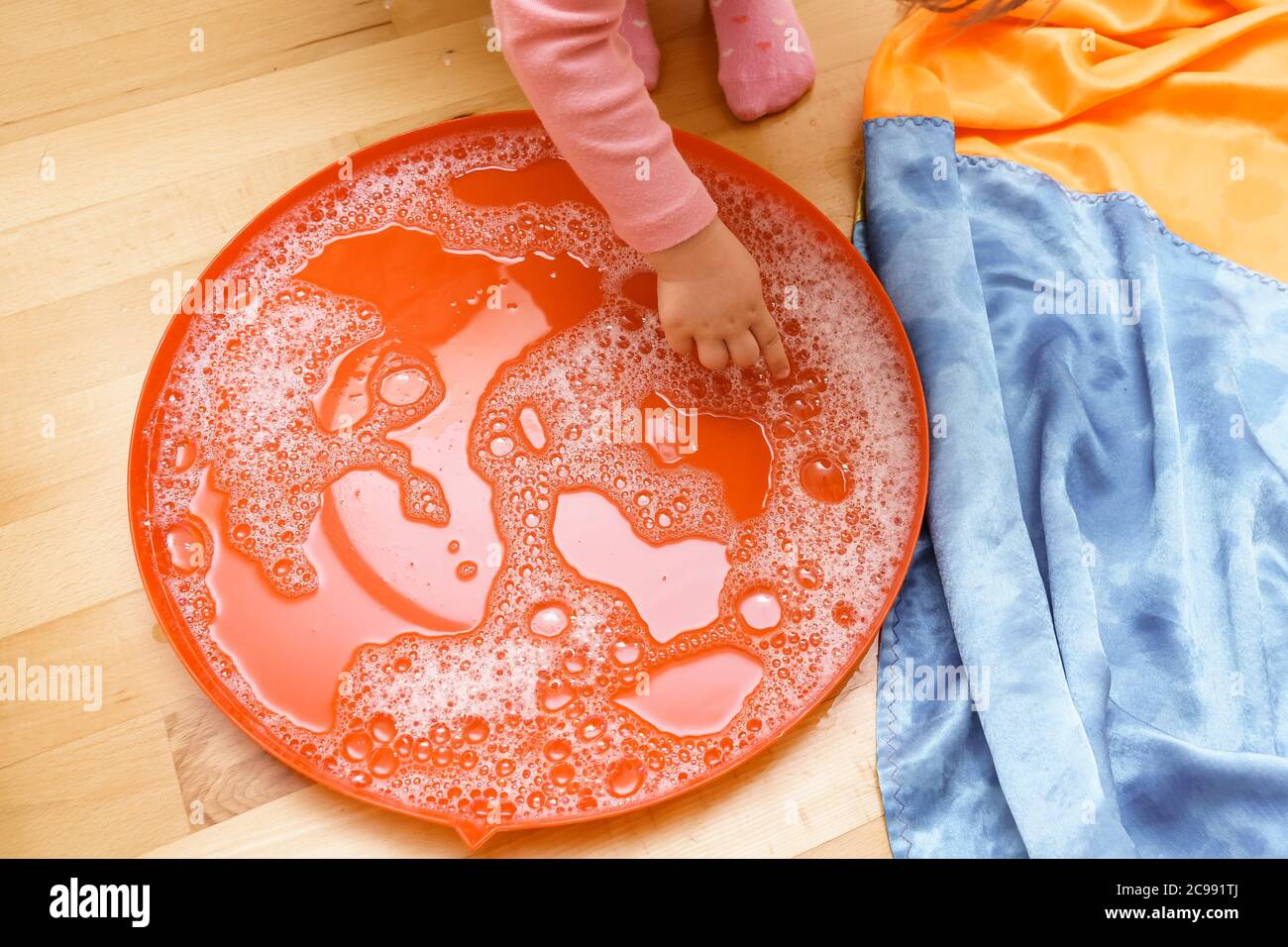 the child touches the soap solution for large soap bubbles Stock Photo ...