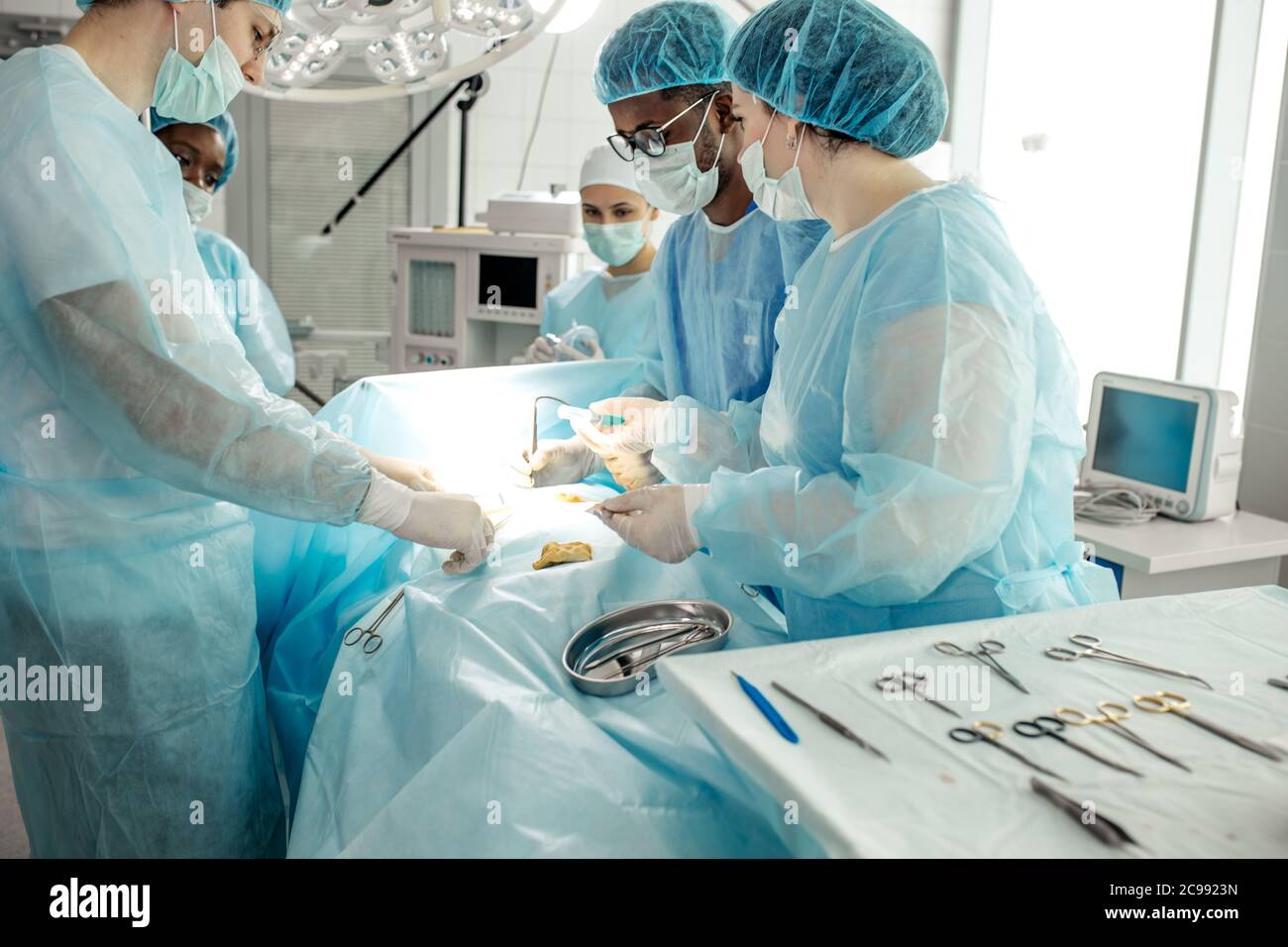 doctors in special uniform smearing antibiotic cream on the wound ...