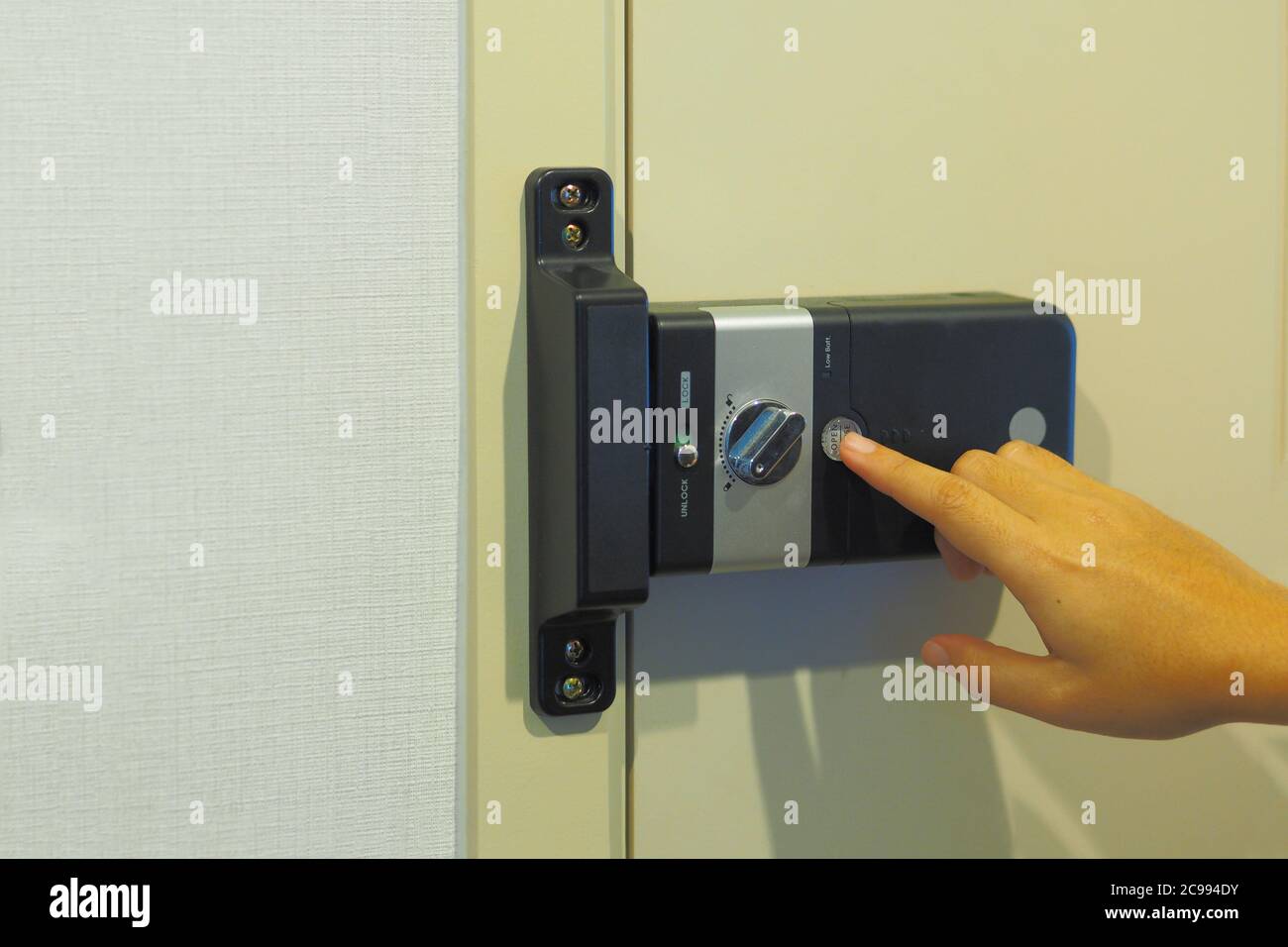 Women are using a key card to open the door to enter the room in the ...