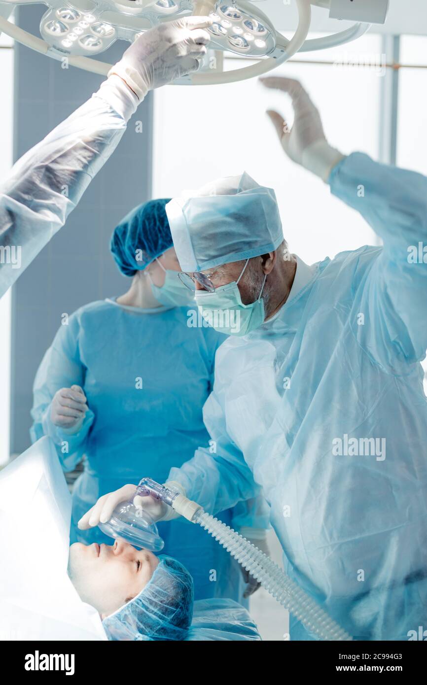 skilled doctor helps to injured patient, man and his colleagues do ...