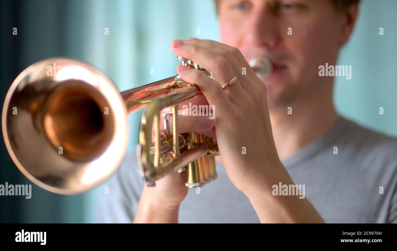 A young man plays the trumpet. Hands of musician. Close up view Stock ...