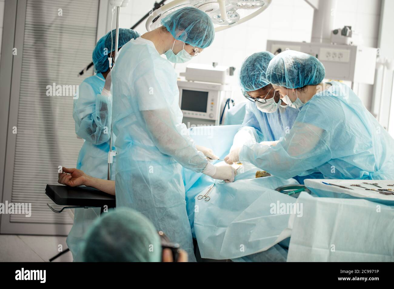 medical specialists performing abdominoscopy and laparoscopy. side view ...