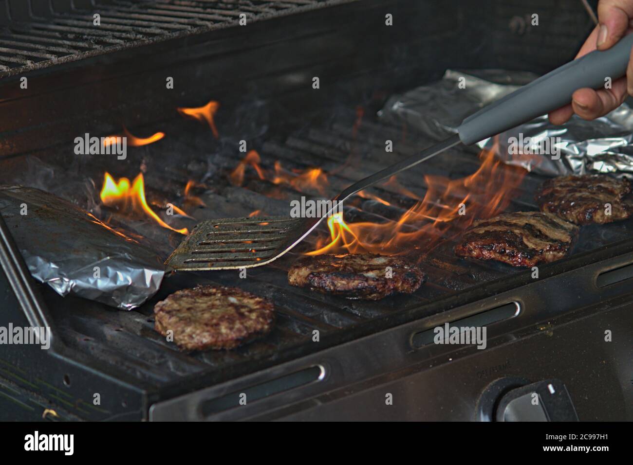 Cooking burgers flip hi-res stock photography and images - Alamy