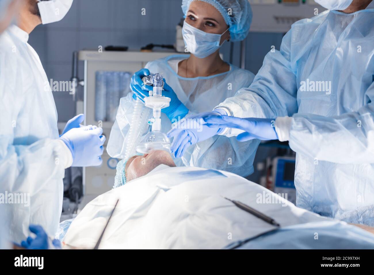 Team of experienced doctors and assistants performing difficult ...