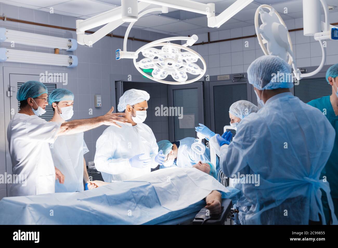 Doctor checking patient during procedure hi-res stock photography and ...