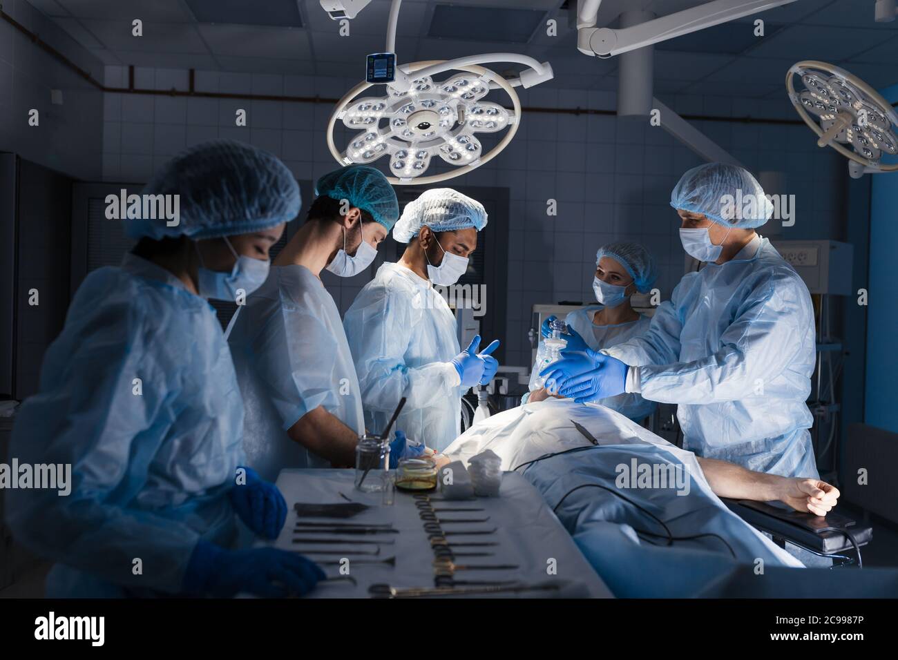 The anesthesiologist team takes care of patient lying on operation ...
