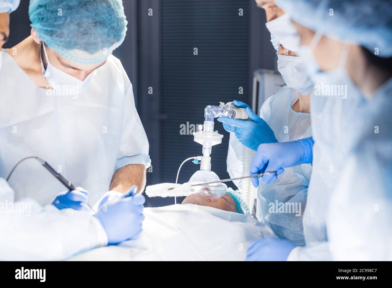 Concentrated Surgical team operating a patient in an operation theater ...