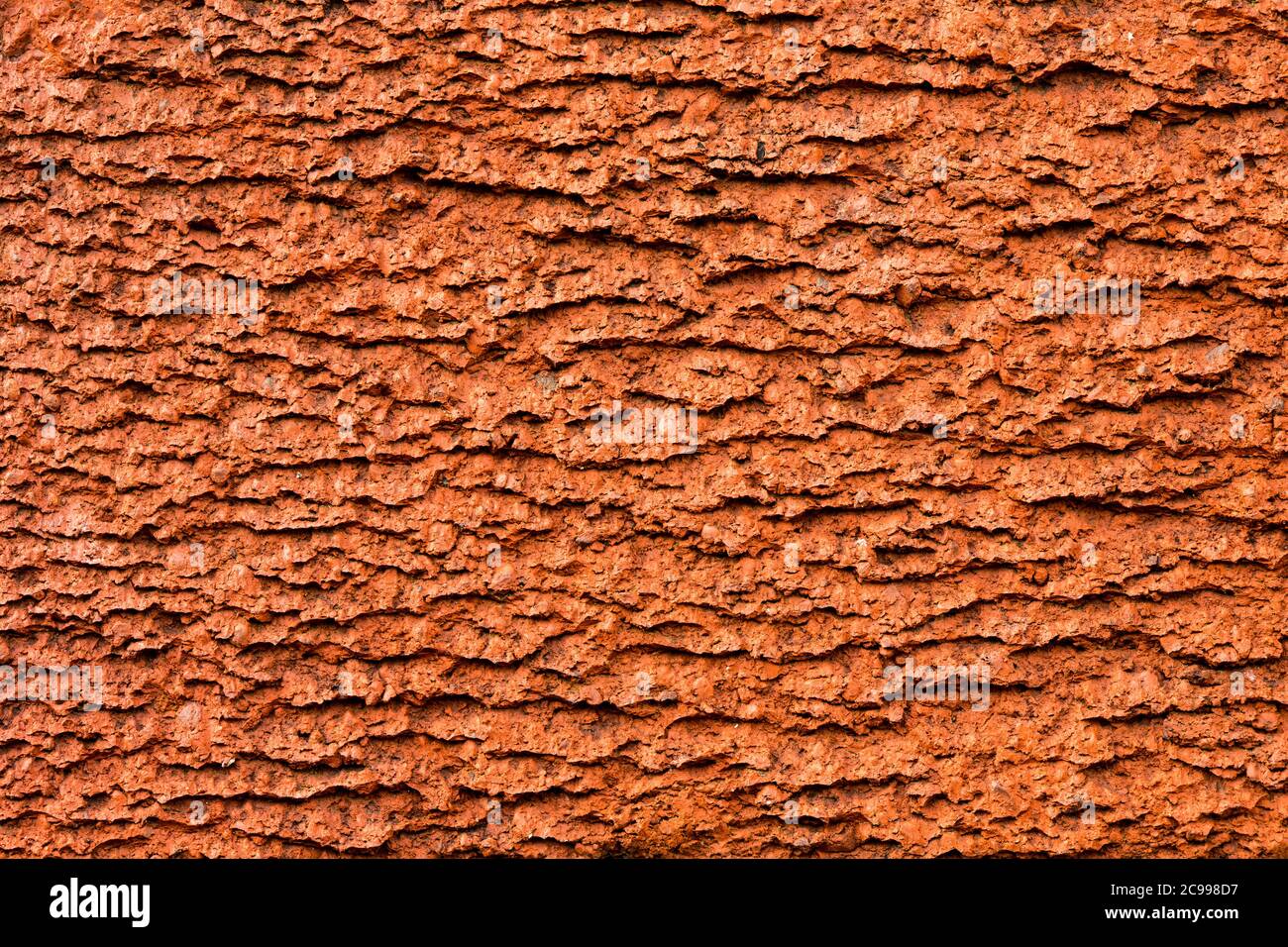 Close up of a textured brick wall. Red and black patterns in the ...