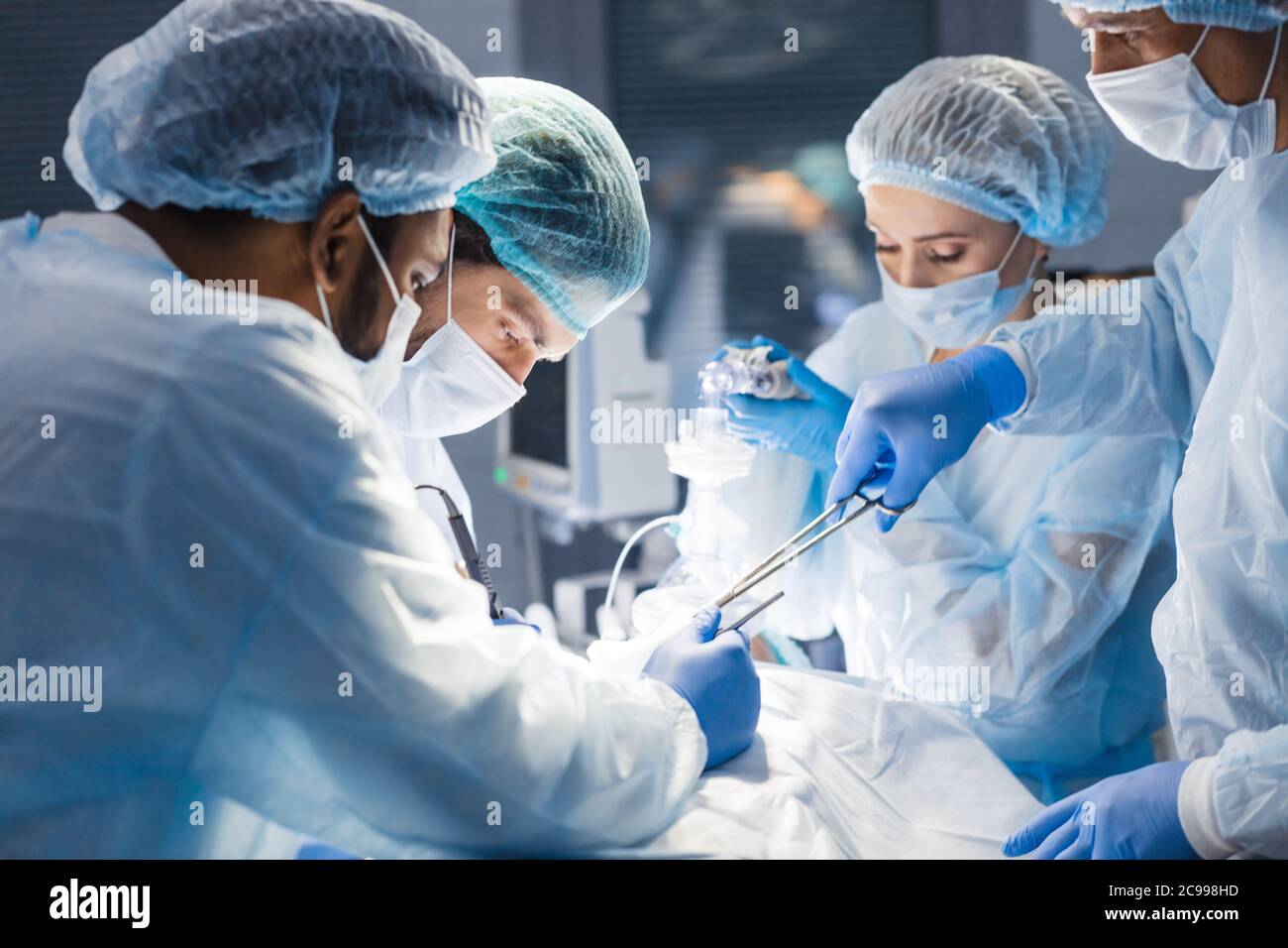 Concentrated Surgical team operating a patient in an operation theater ...