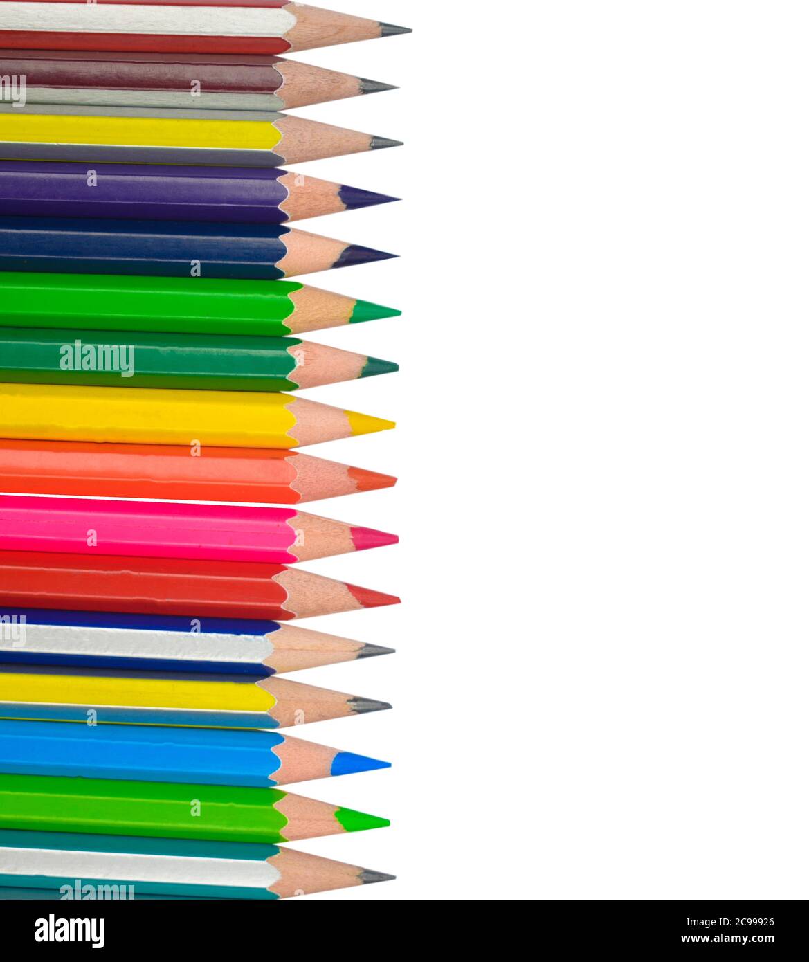 One line of different colored wood pencil crayons placed on an isolated ...