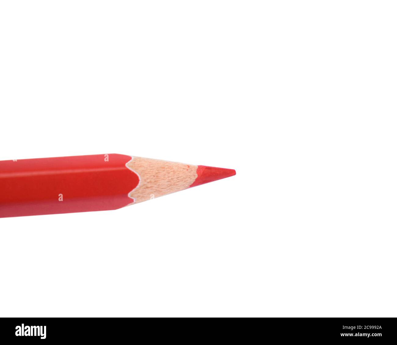 One red colored wood pencil crayons placed on an isolated white paper ...