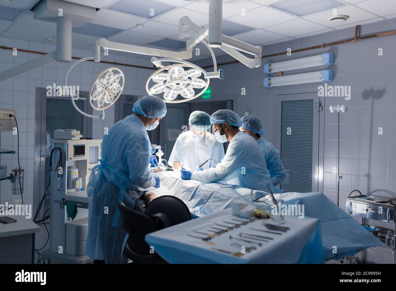 Multiracial Team of Surgeons concentrating on a patient during a heart ...