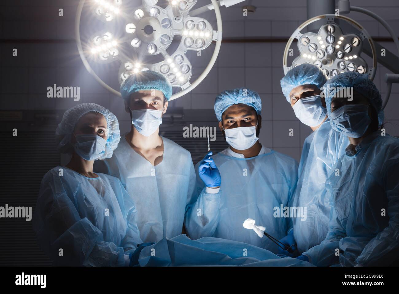 Shot of a multiracial surgeon team consists of trained surgeons, trauma ...