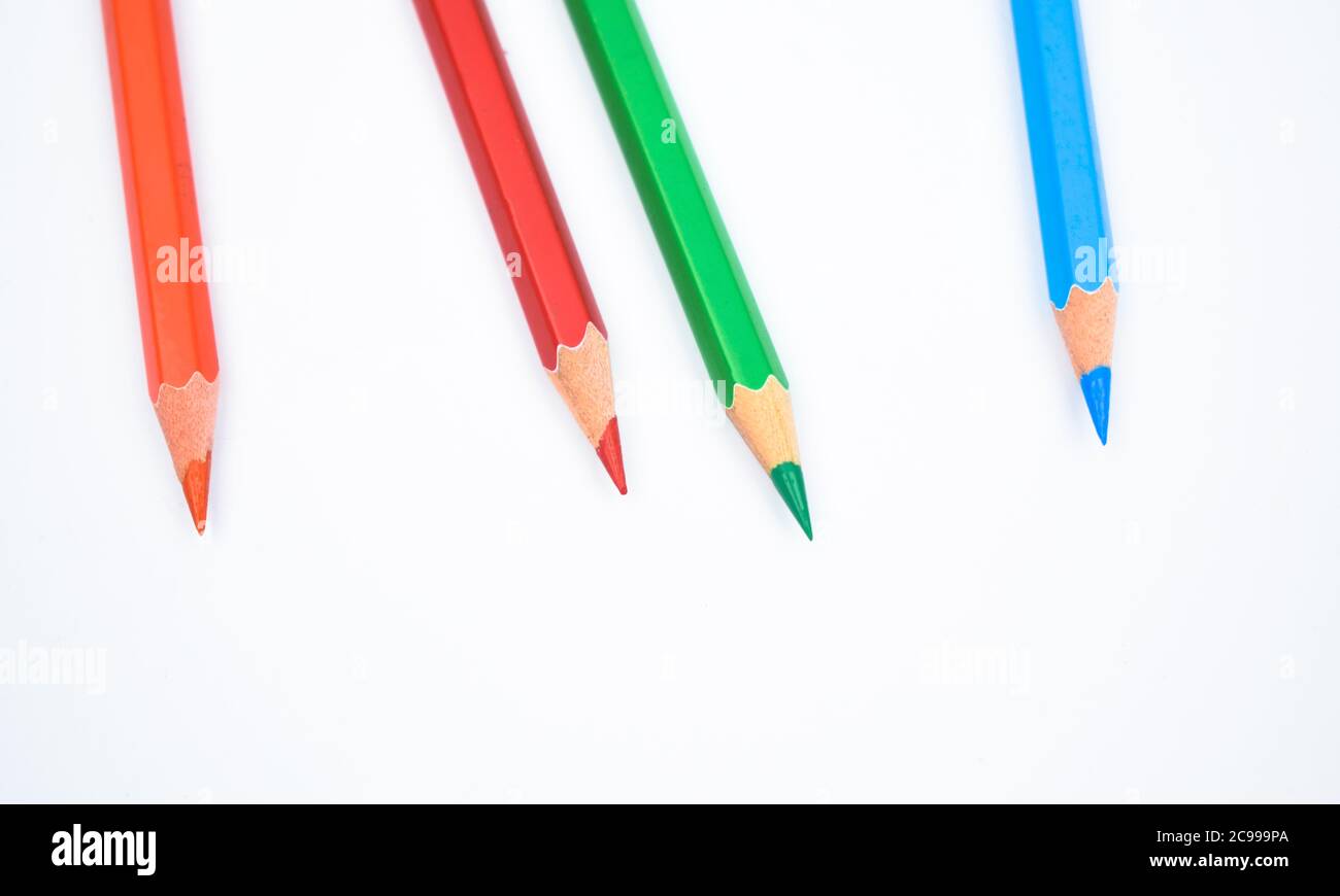 Three different colored wood pencil crayons placed on an isolated white ...