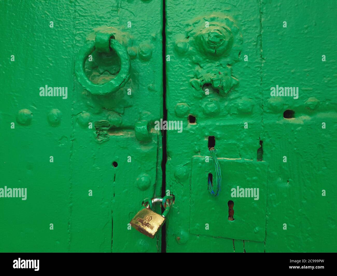 Green door with a lock in Asilah medina, Morocco Stock Photo - Alamy