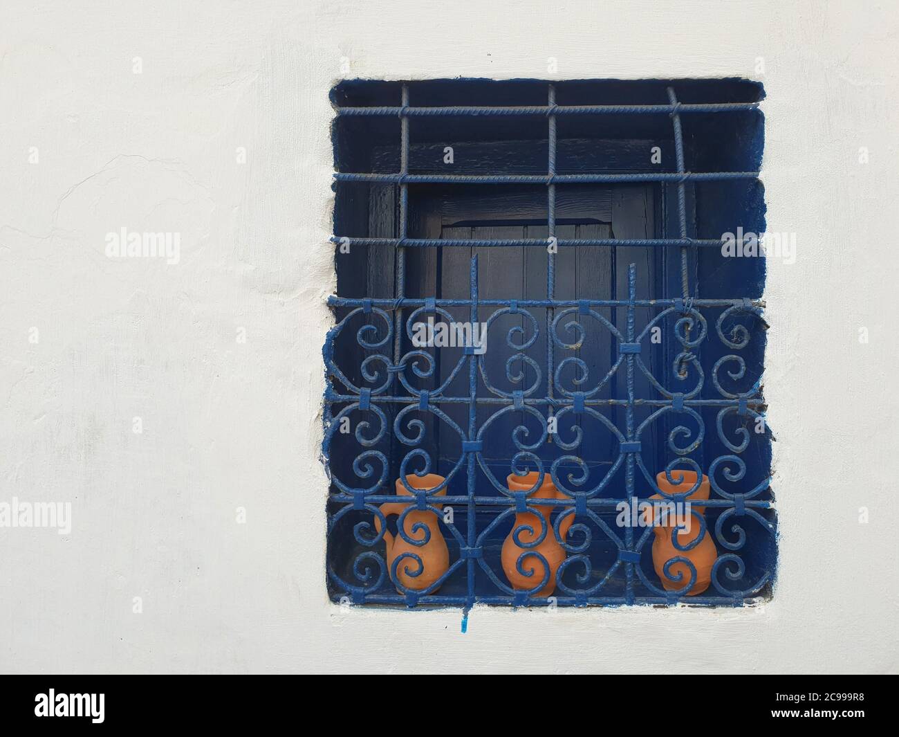 Old blue window with trellises and pots in Asilah medina, Morocco Stock ...