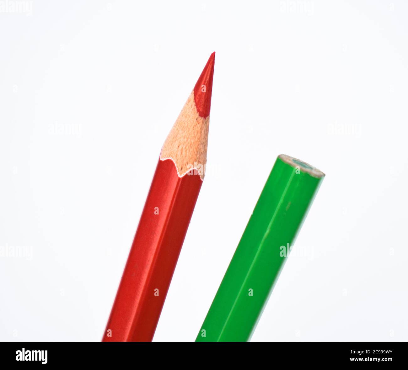 Two different colored wood pencil crayons placed on an isolated white ...