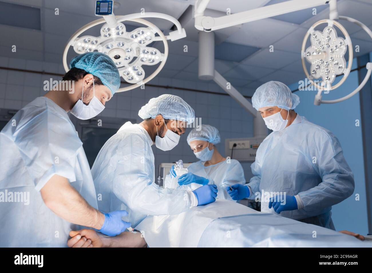Complex surgery. Skilful surgeon works with scalpels and clamps during ...
