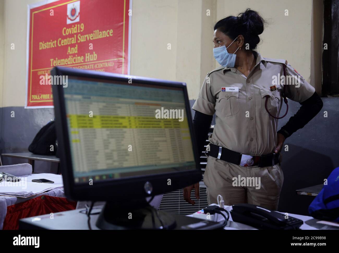 An Indian volunteer from Delhi Civil Defence (DCD) wearing face masks ...