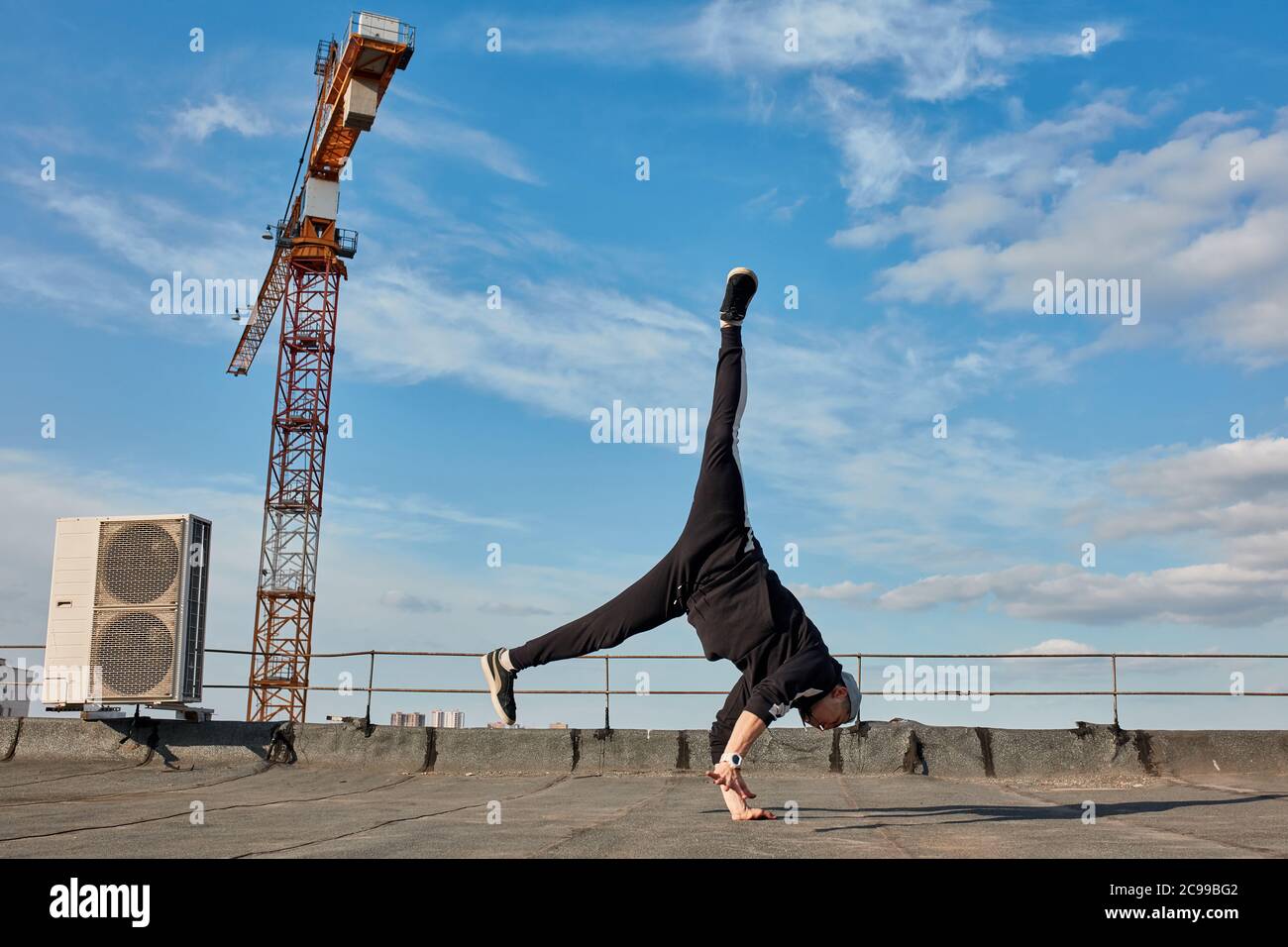 Street dancer hipster guy makes back flip with arm support. Asian ...