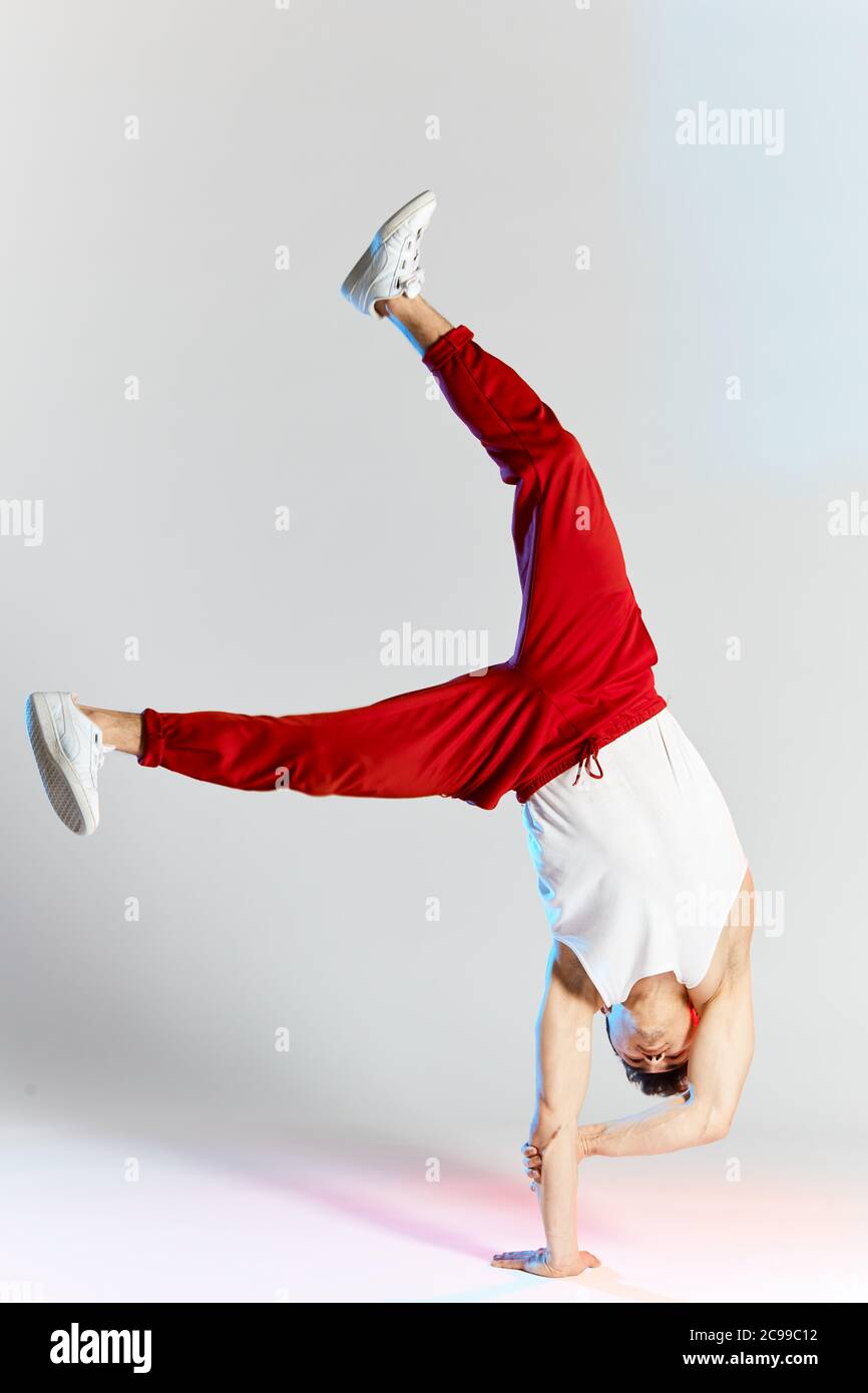 Chinese break dancer in red sweatpants showing his skills on white ...