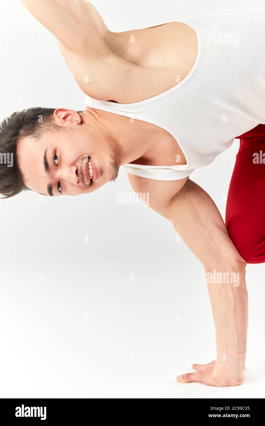 Free style dancer in red sports trousers doing some acrobatic stunts ...