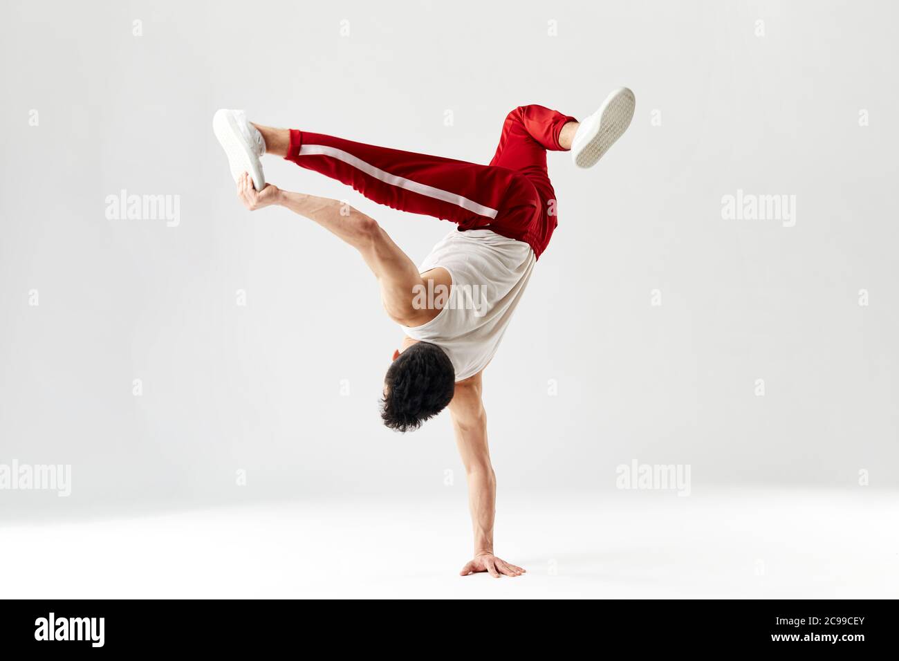 Isolated Korean hip hop male break dancer dancing on white background ...
