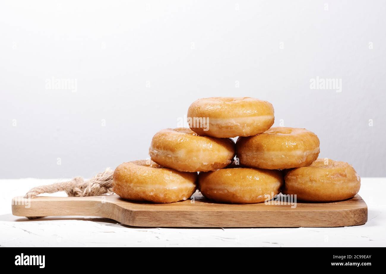 wooden board with doughnuts stacked on top of each other forming a ...