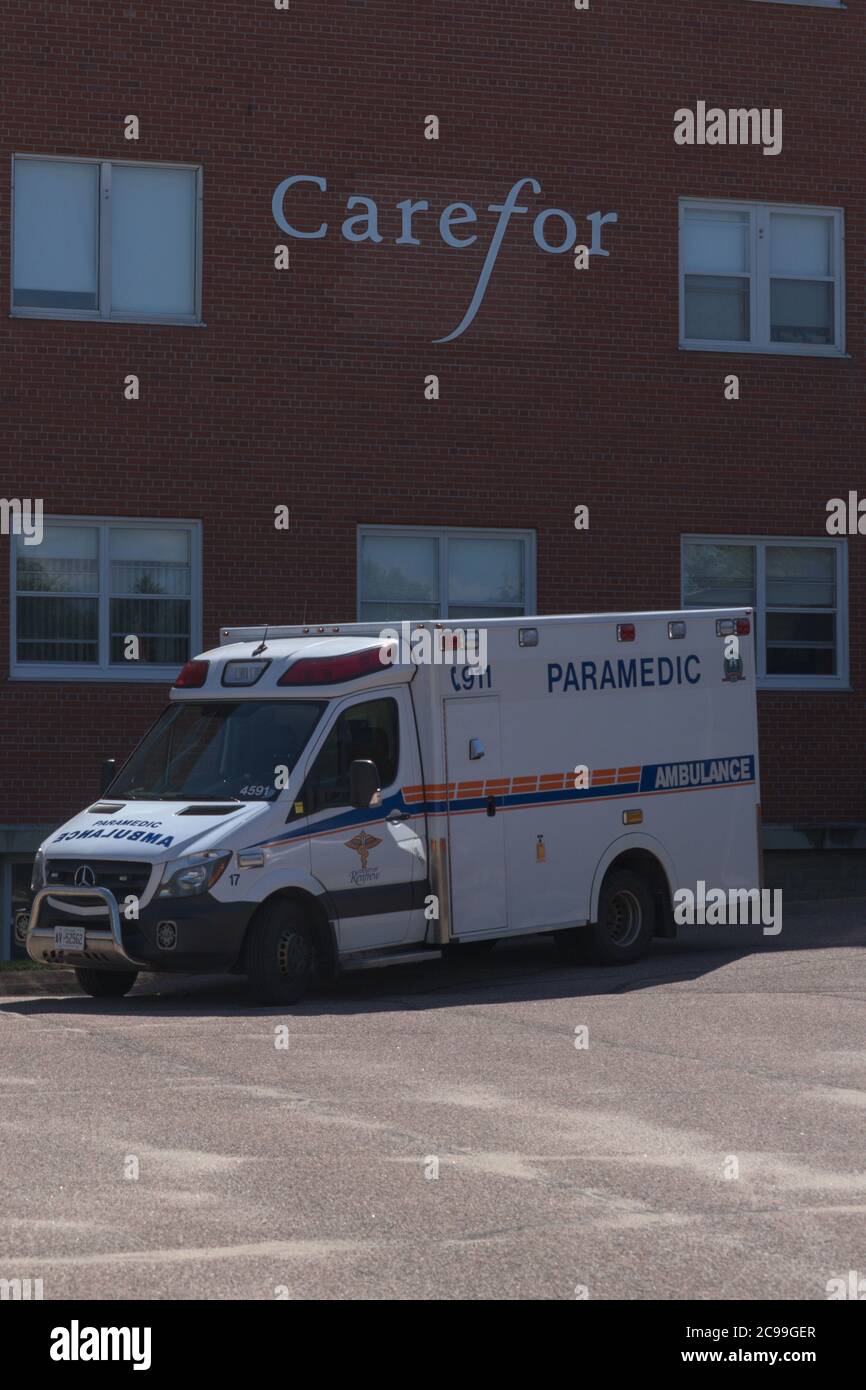 ambulance sitting outside carefor medical building Stock Photo - Alamy