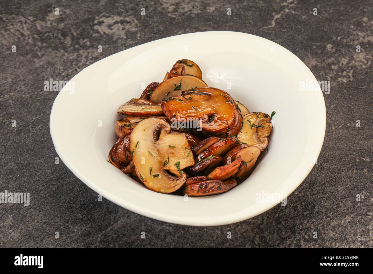 Roasted champignon with herbs and spices in the bowl Stock Photo - Alamy