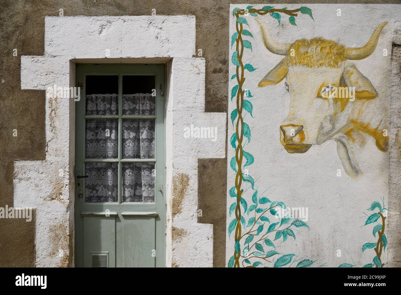 Painting of a cow head on a diisused butchery, Clamecy, Nièvre ...