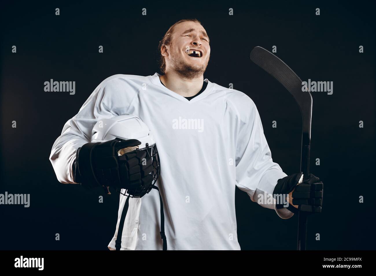 Happy Handsome hockey player with one broken front tooth laughing at ...