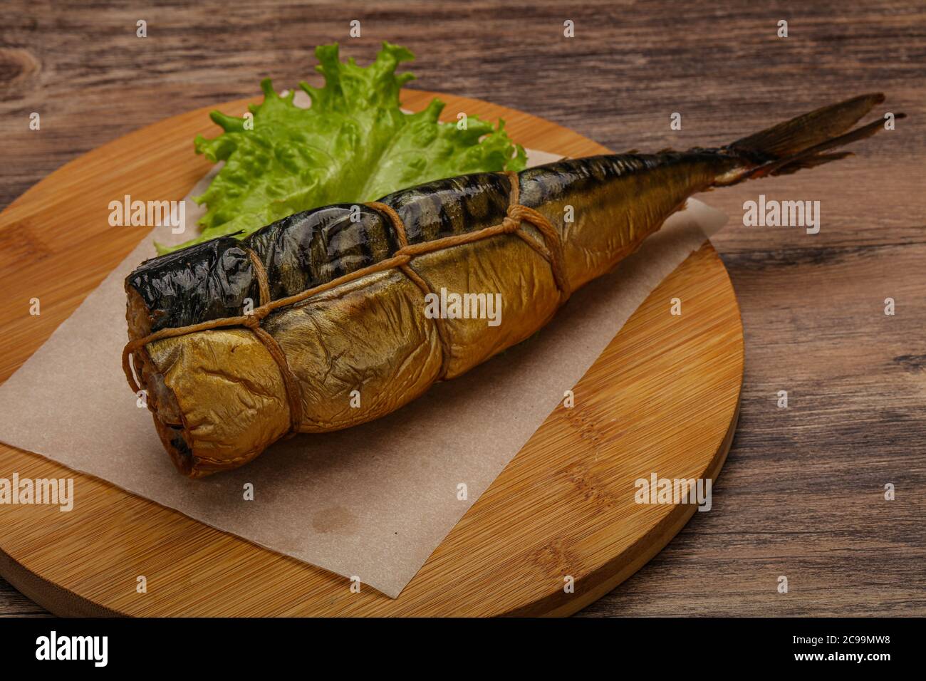Smoked tasty mackerel fish snack over board Stock Photo - Alamy