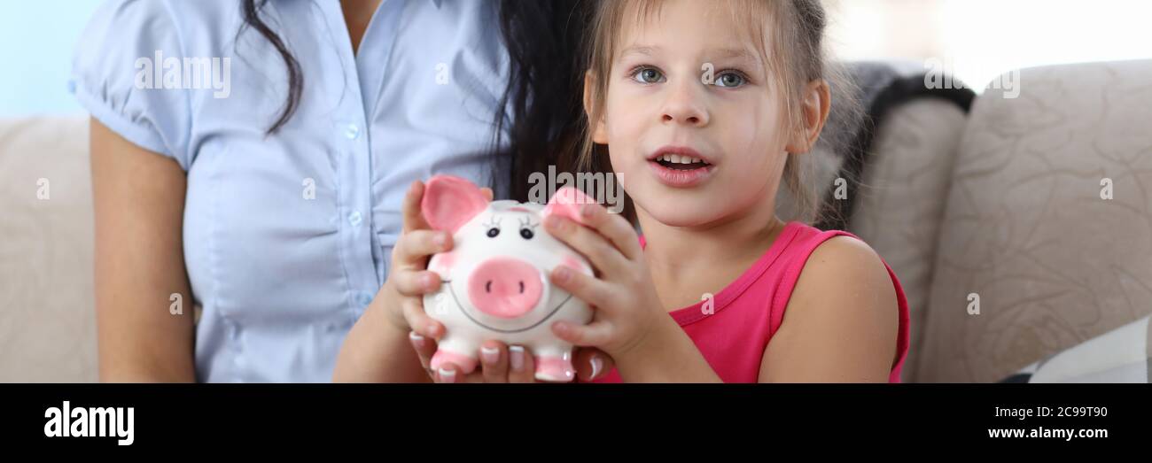 Child holding money box Stock Photo - Alamy