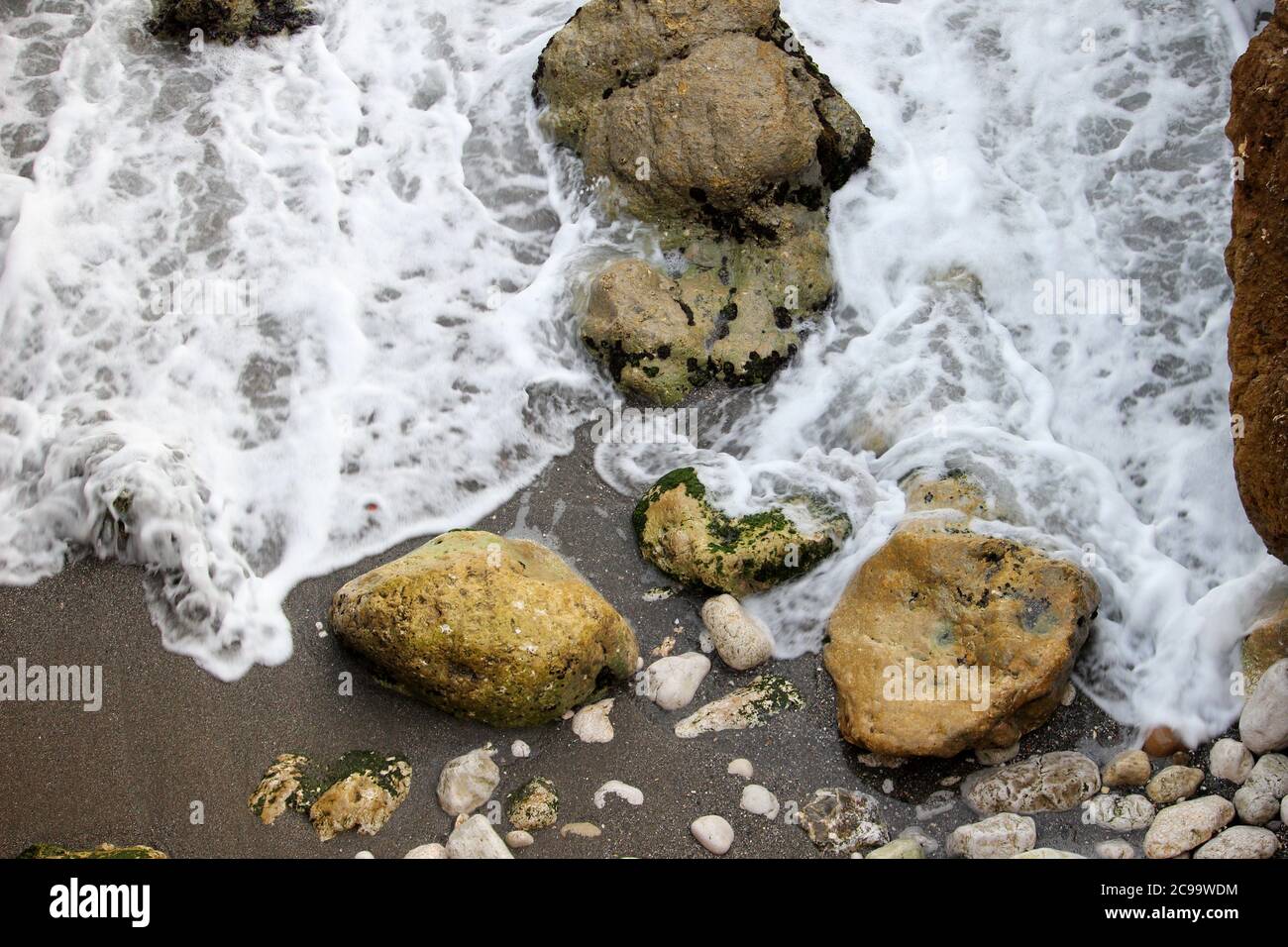 Close up shot of a the rocky sand of a coastline Stock Photo - Alamy