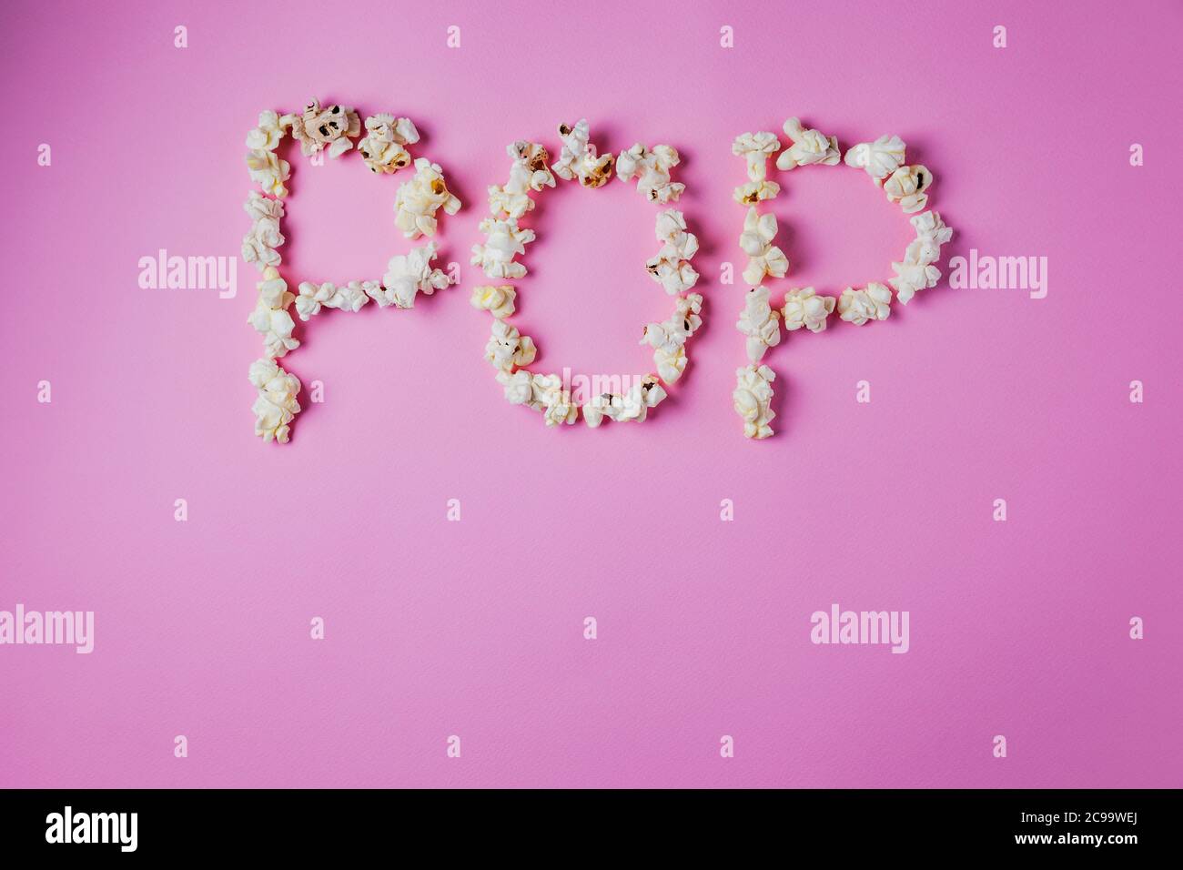 Word POP written with popcorn on pink background, copy space Stock ...