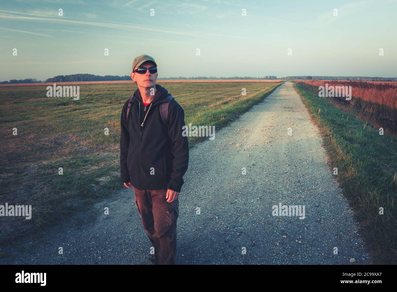 Man walking lonely road hi-res stock photography and images - Alamy