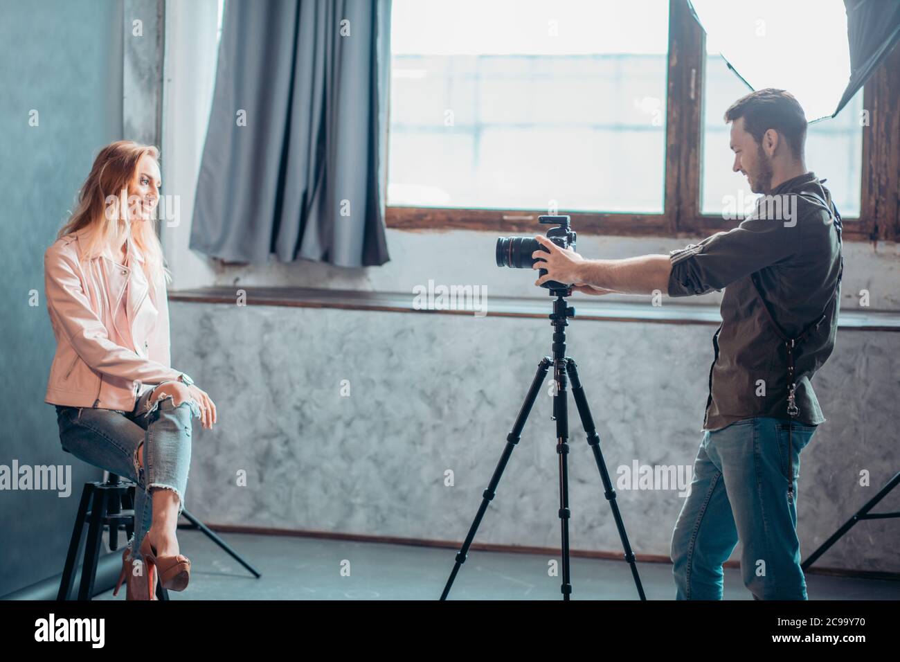 Young beautiful blond model posing in chair for a professional ...