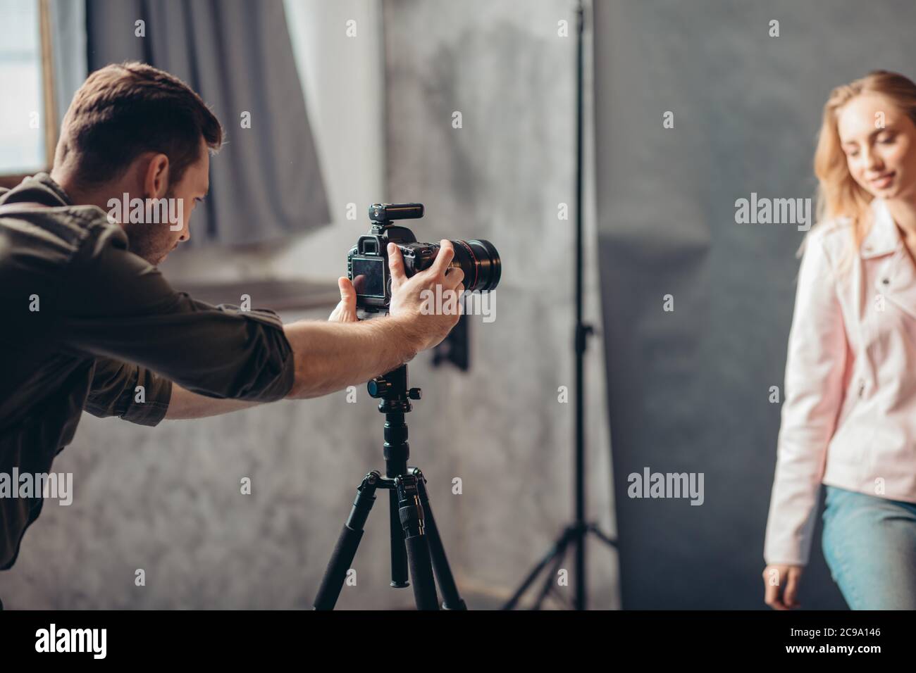 young man concentrated on making a photo at workplace. side view photo ...