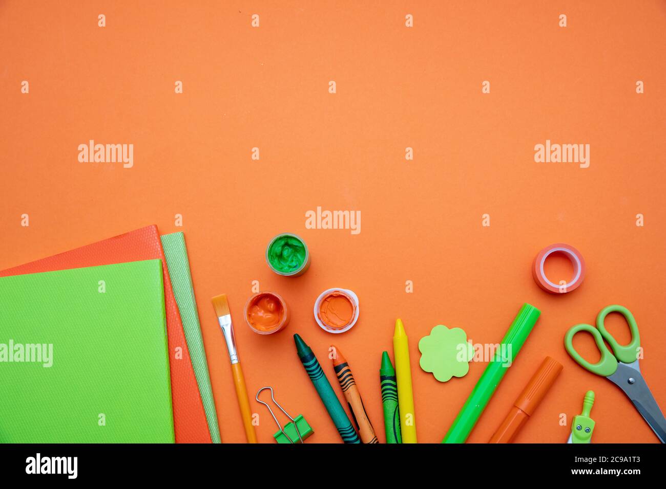 School supplies. Stationery border on orange color background, top view ...