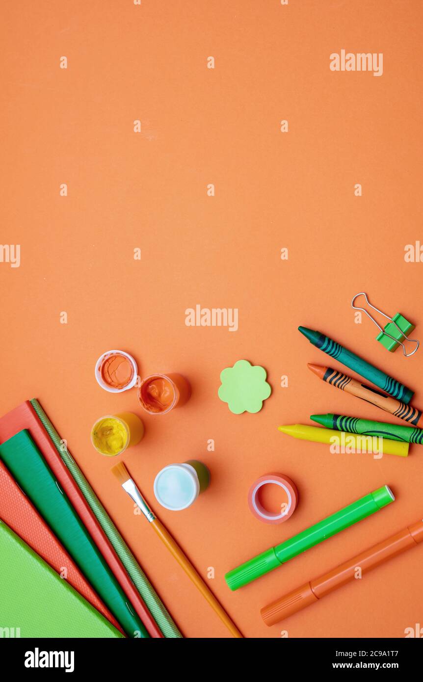 School supplies. Stationery border on orange color background, top view ...