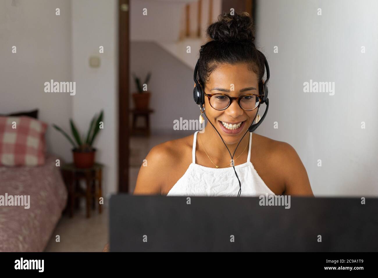 Working brazilian young woman in bedroom. Telemeeting. Video conference ...