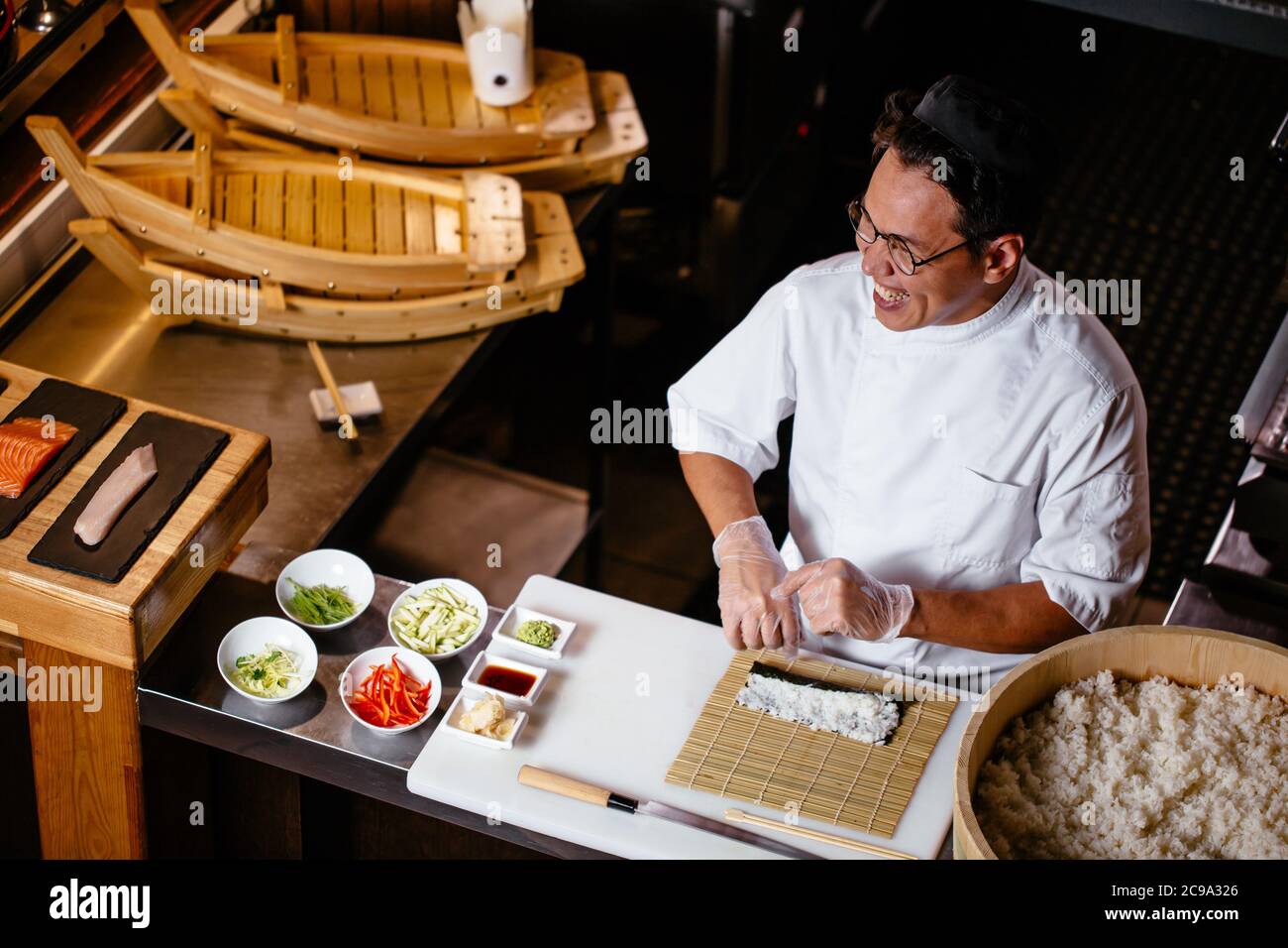 chef laughing at something while working in the kitchen. close up photo ...