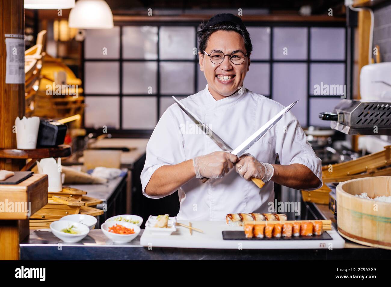 happy pleasant guy holding knives and looking to the camera Stock Photo ...