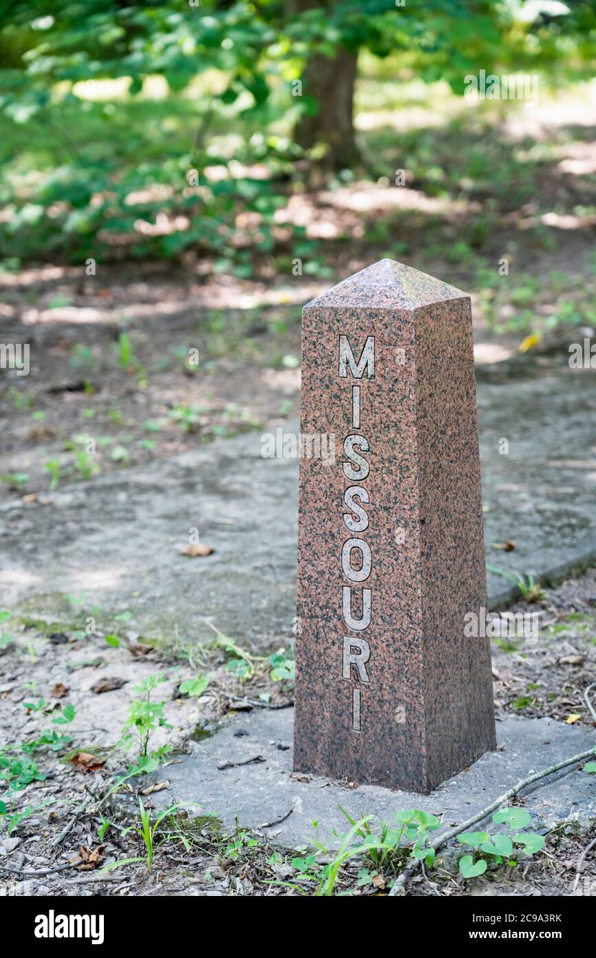 red granite pillar in a park with the name Missouri, one of the United ...