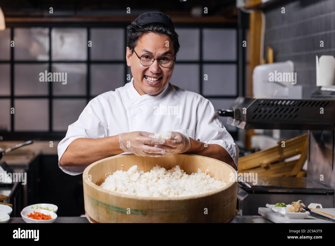 Chinese smiling chef cooking in a restaurant kitchen. close up photo ...