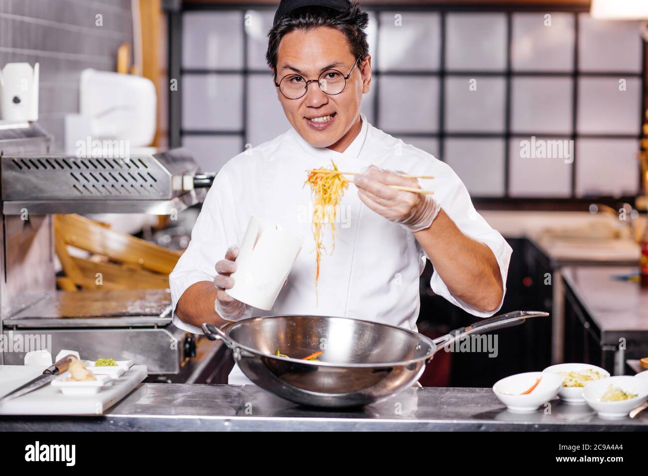 chinese attractive man with noodle posing to the camera, chinese ...