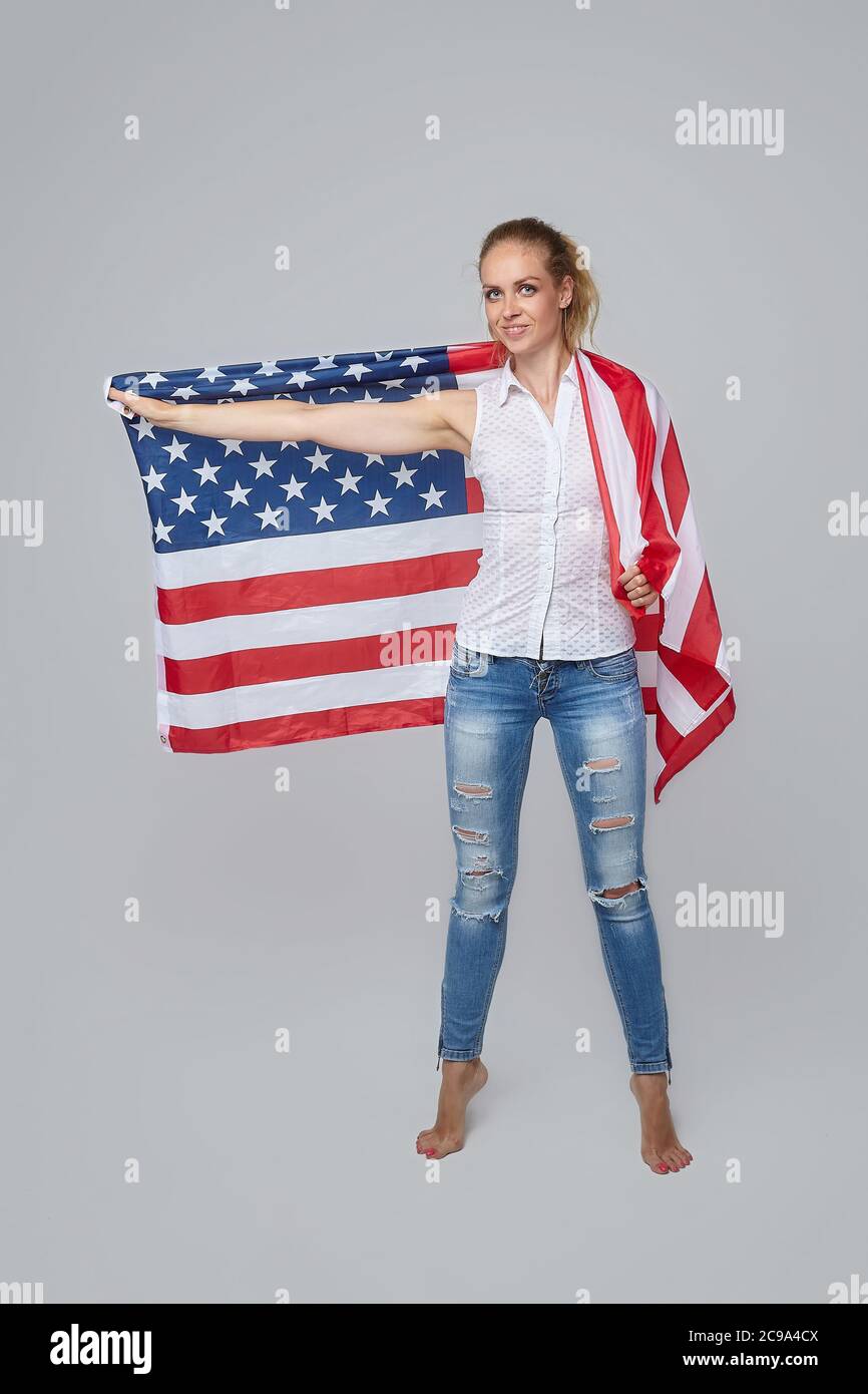 blonde woman posing with usa flag in studio on white background Stock ...