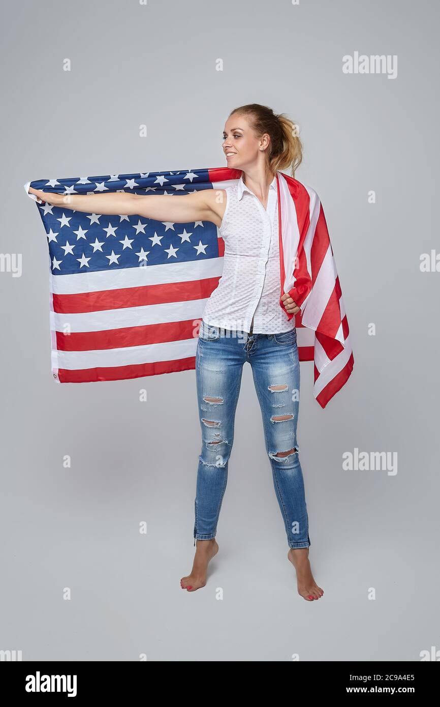 blonde woman posing with usa flag in studio on white background Stock ...