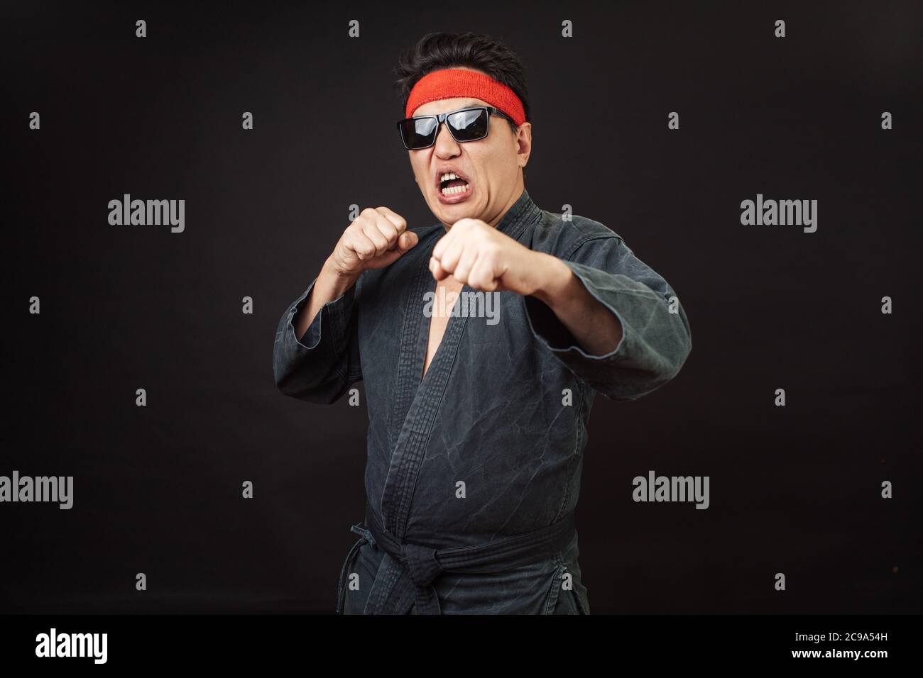 cool karate fighter in sunglasses. comical man in kimono with clenched ...